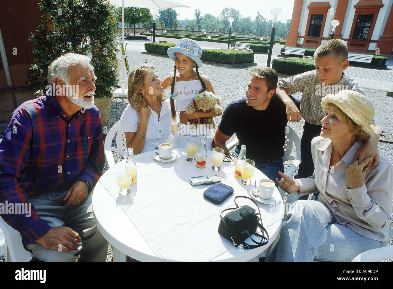Family group around a table outdoors hi-res stock photography and ...