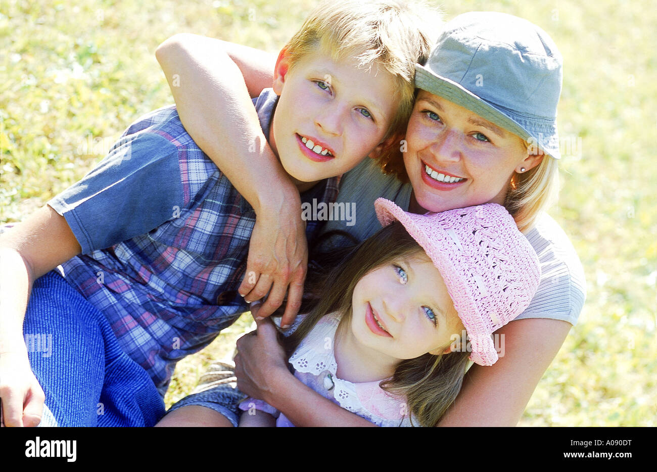 Mother hugging her kids Stock Photo - Alamy