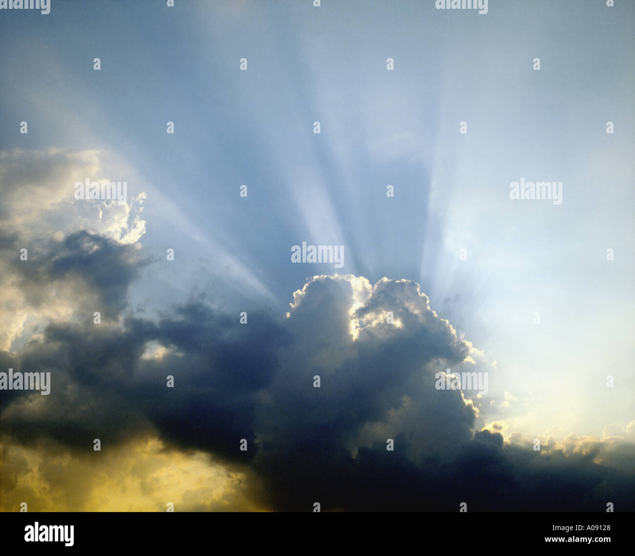Sun rays bursting through dramatic clouds Stock Photo - Alamy