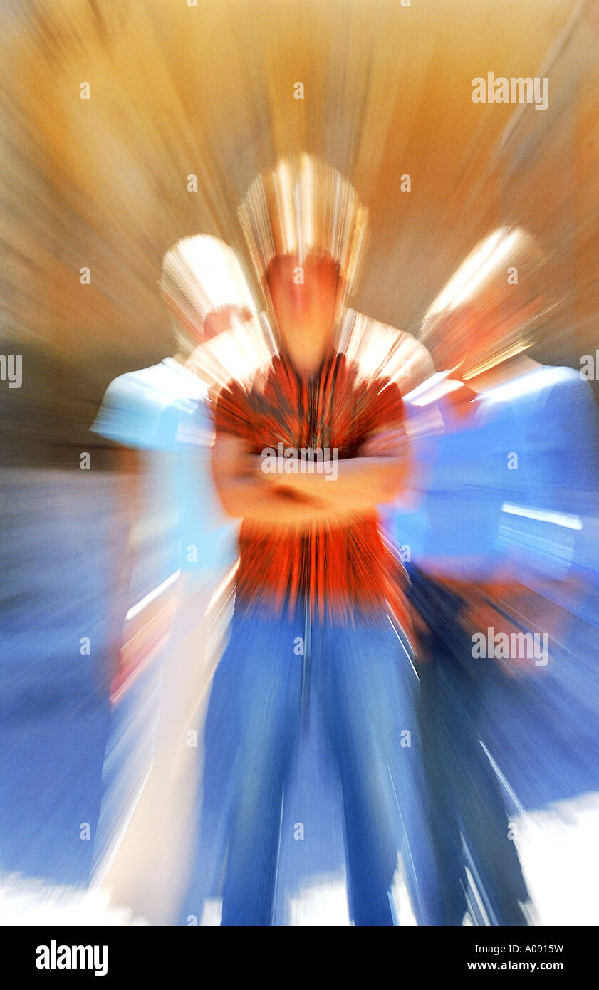 Blurred portrait of a young man standing with two young women Stock ...