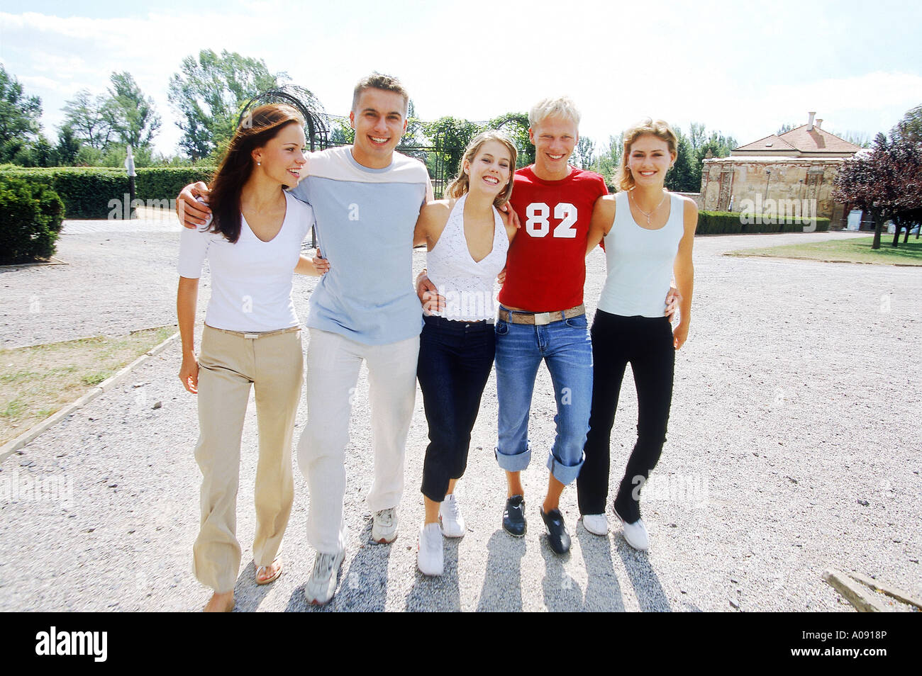 Portrait of a man walking arm in arm with four women Stock Photo - Alamy