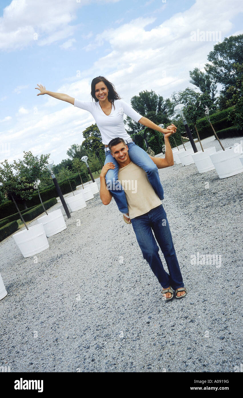 Portrait of a man carrying a woman on his shoulders Stock Photo - Alamy