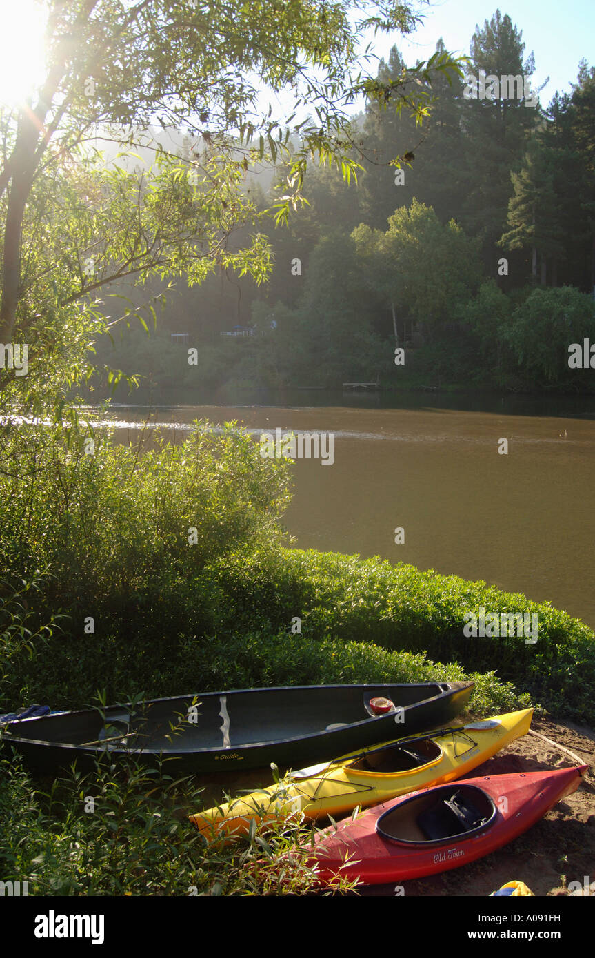 Canoes on Riverbank Stock Photo - Alamy