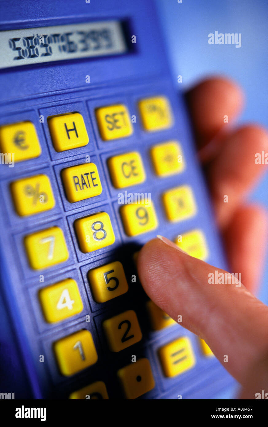 hand on calculator Stock Photo - Alamy