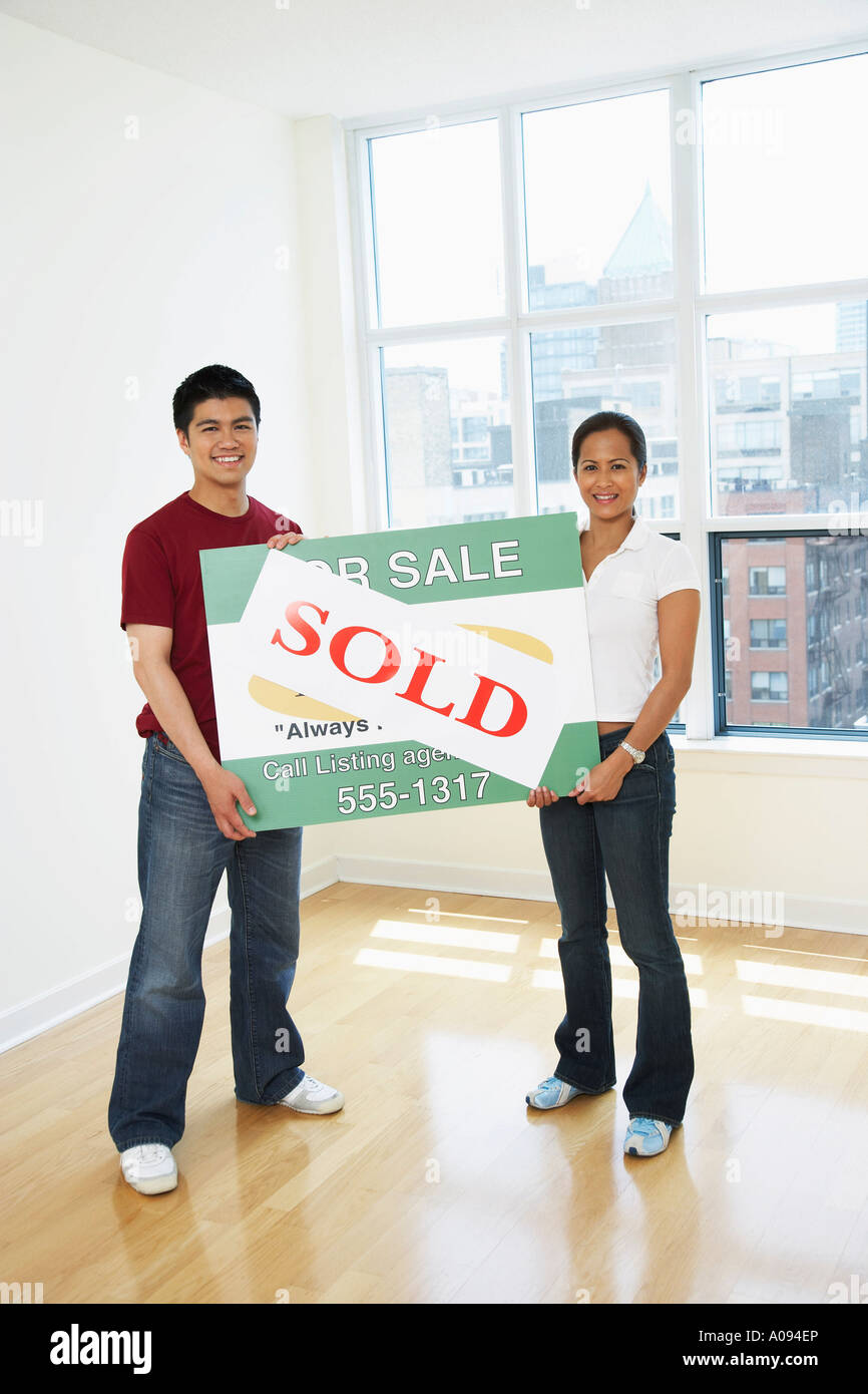 Couple Holding Sold Sign Stock Photo - Alamy