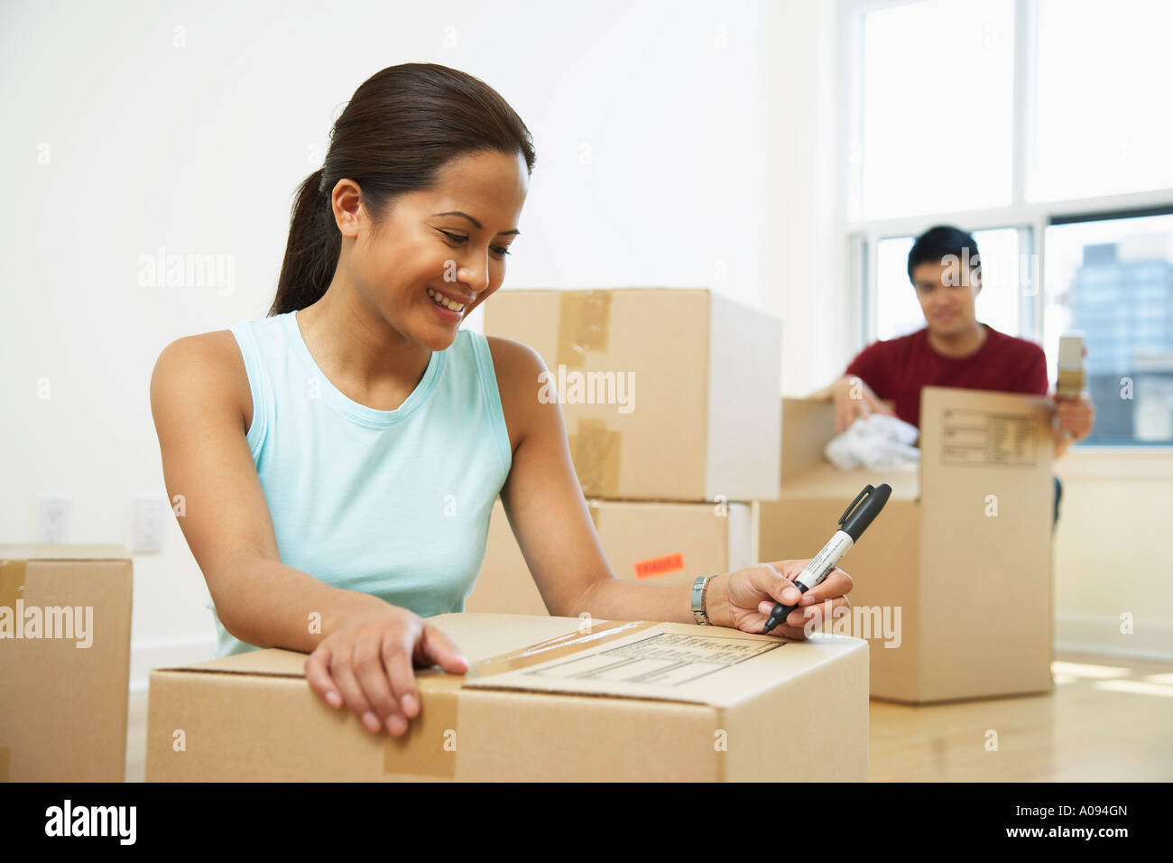 Couple Packing Boxes Stock Photo - Alamy