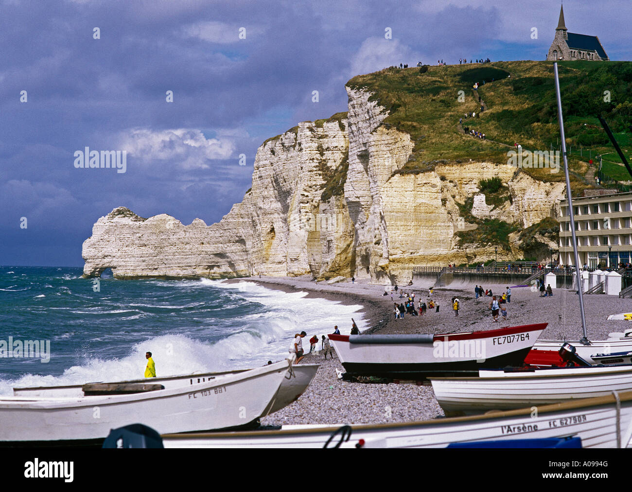 The chalk cliffs of Falaise D Amont tower above the small resort of ...