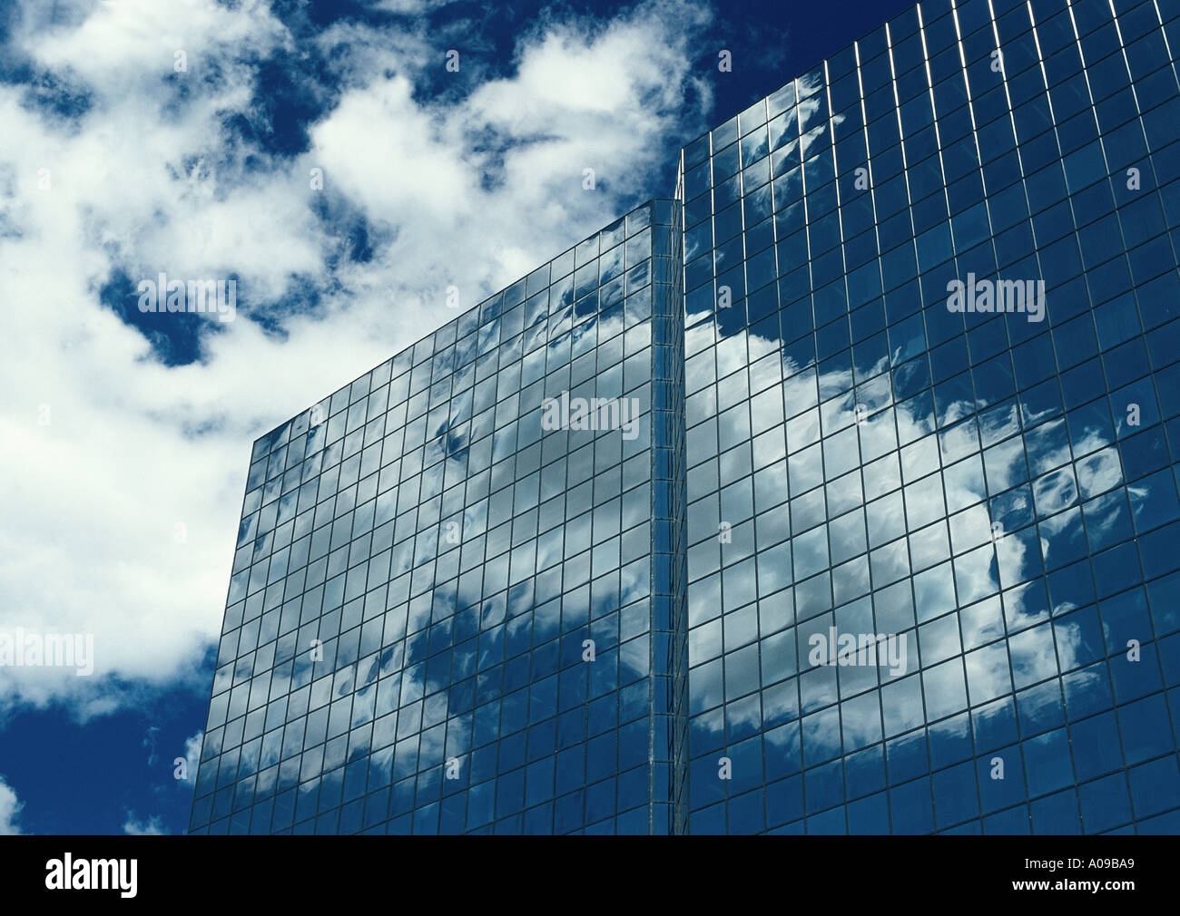 Office tower with blue sky and clouds reflecting in its windows Stock ...