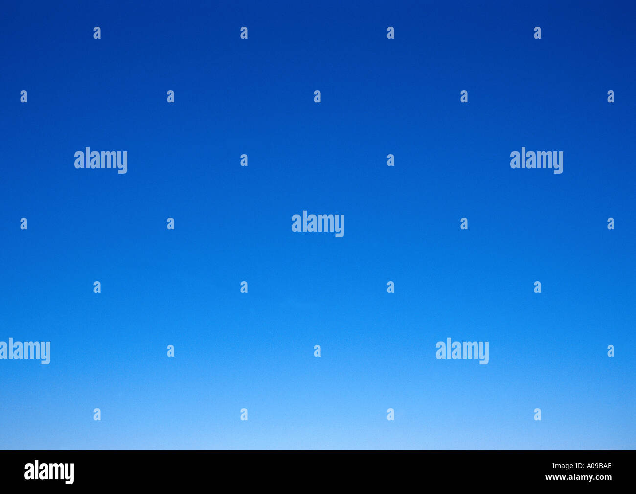 A clear bright daytime skyscape with a cloudless blue sky that ...