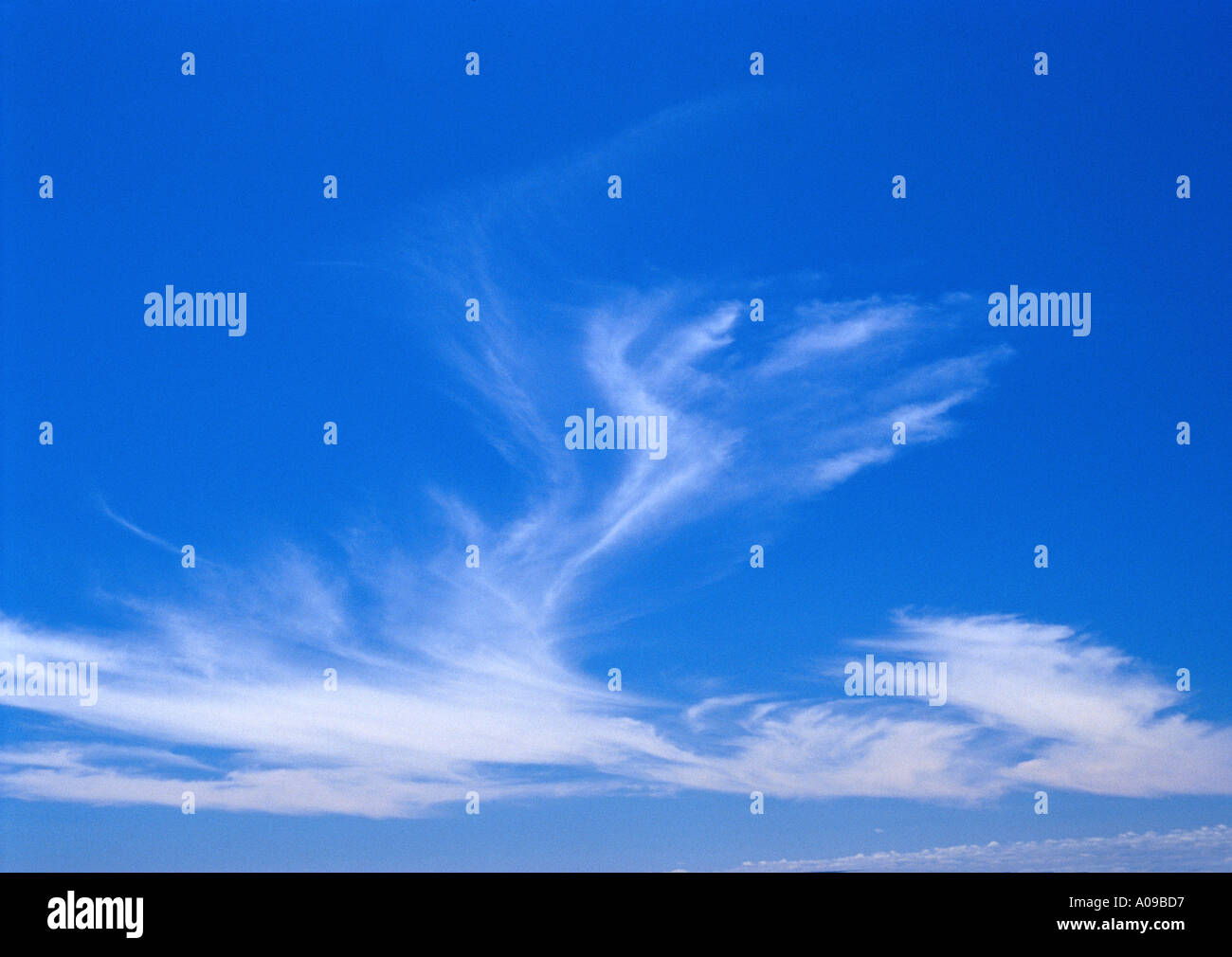 A bright blue daytime skyscape with thin white wispy clouds in the ...
