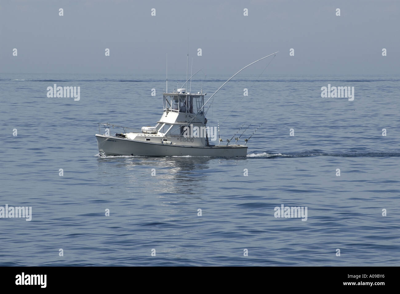 A Small Fishing Boat Floats on the Ocean Stock Photo - Alamy
