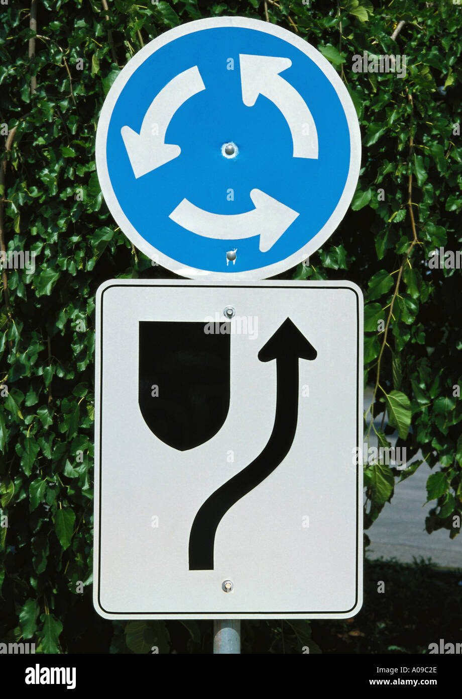 Circular roundabout sign above a rectangular veer right road sign Stock ...