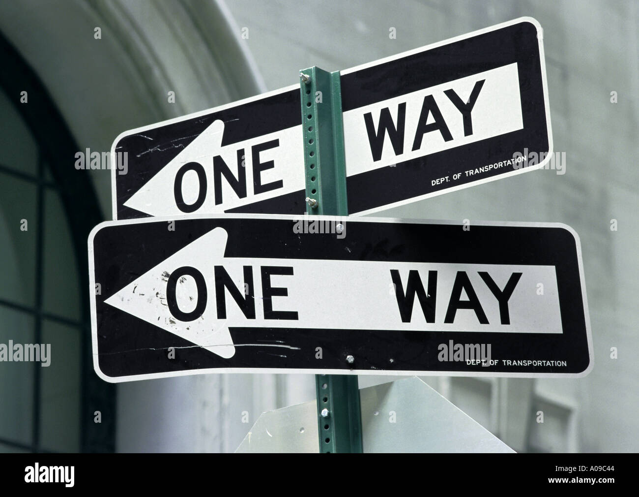 Two one way arrow signs in an urban setting Stock Photo - Alamy