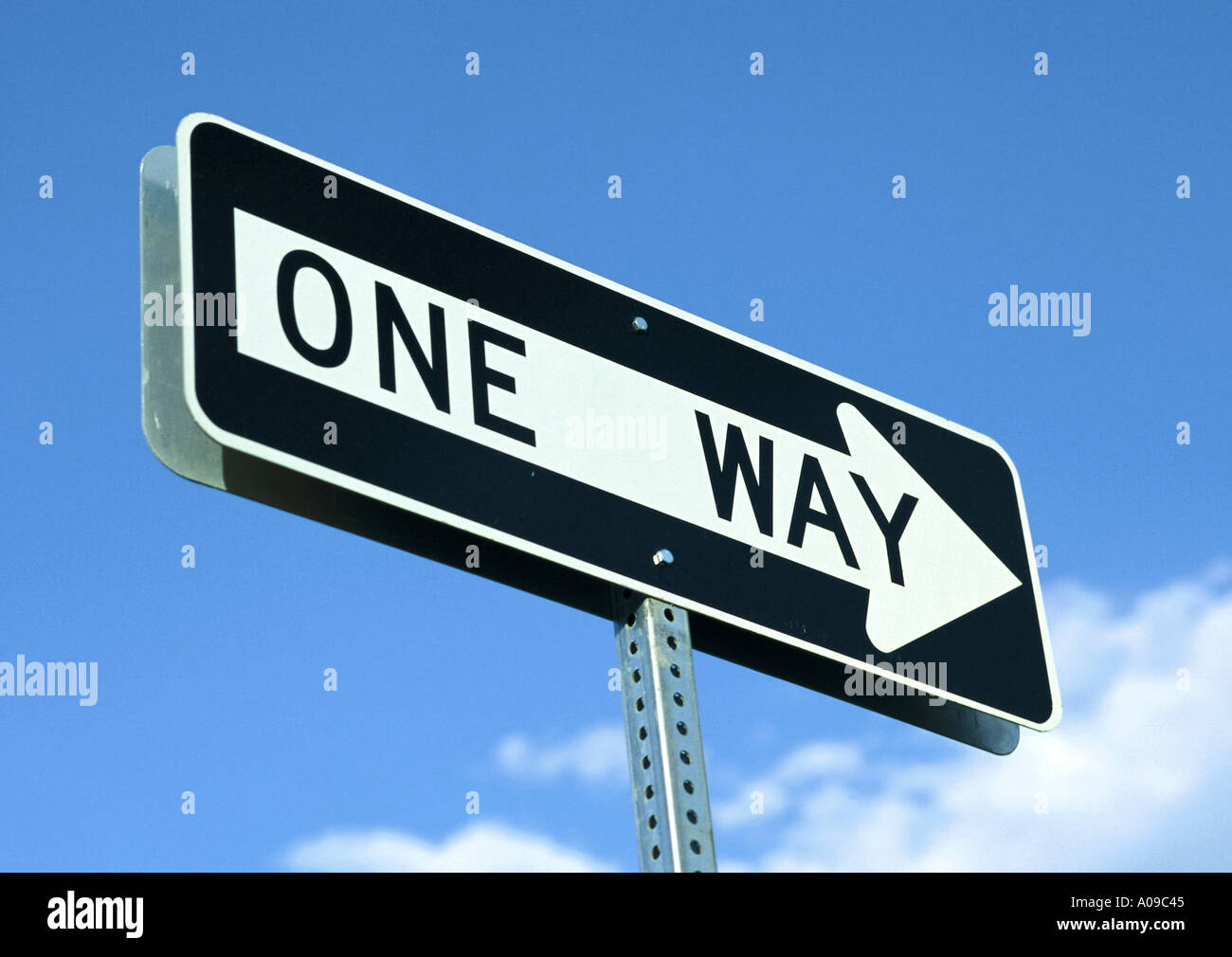 ONE WAY directional road sign with a blue sky background Stock Photo ...