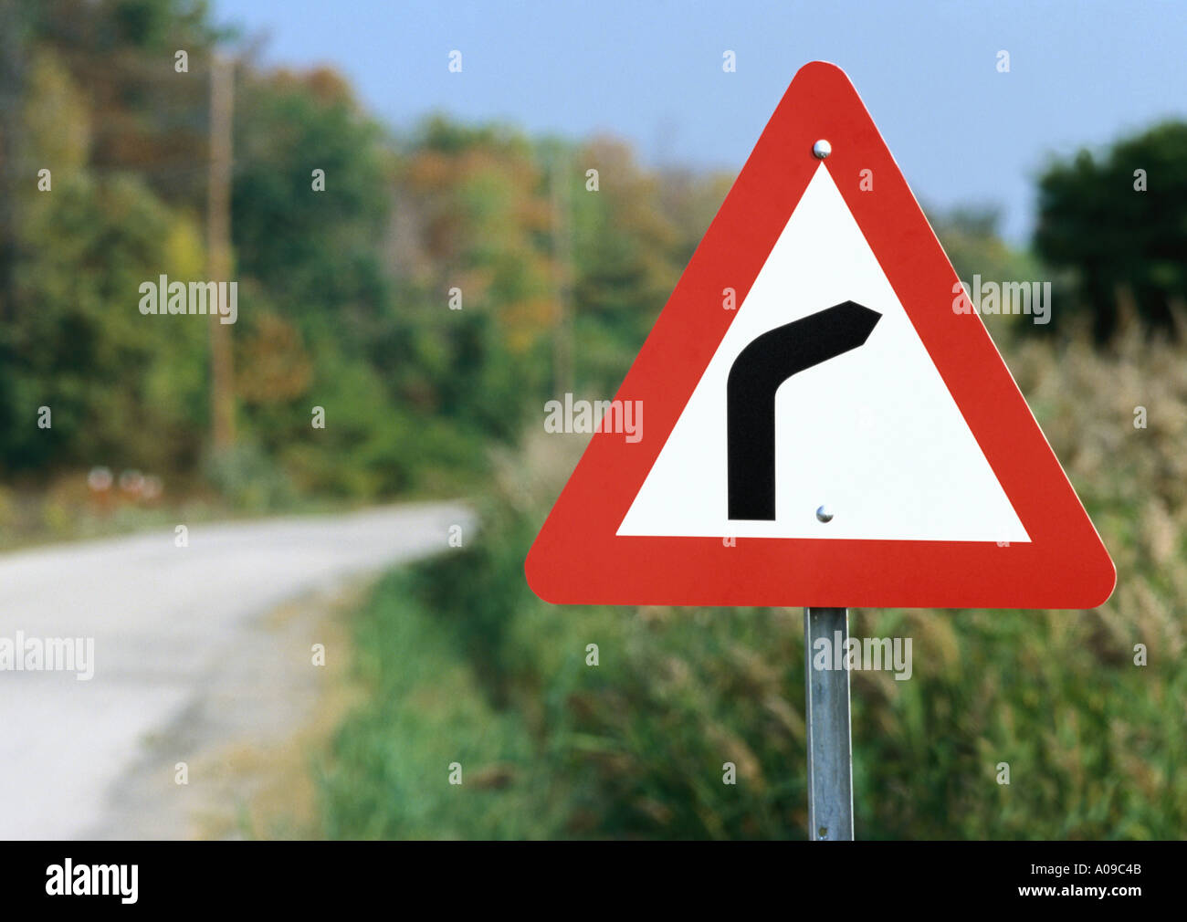 Triangular caution bend to right directional road sign Stock Photo - Alamy