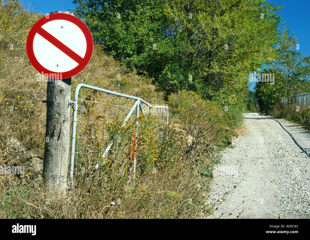 Circular blank entry prohibited road sign on a wooden gate post Stock ...