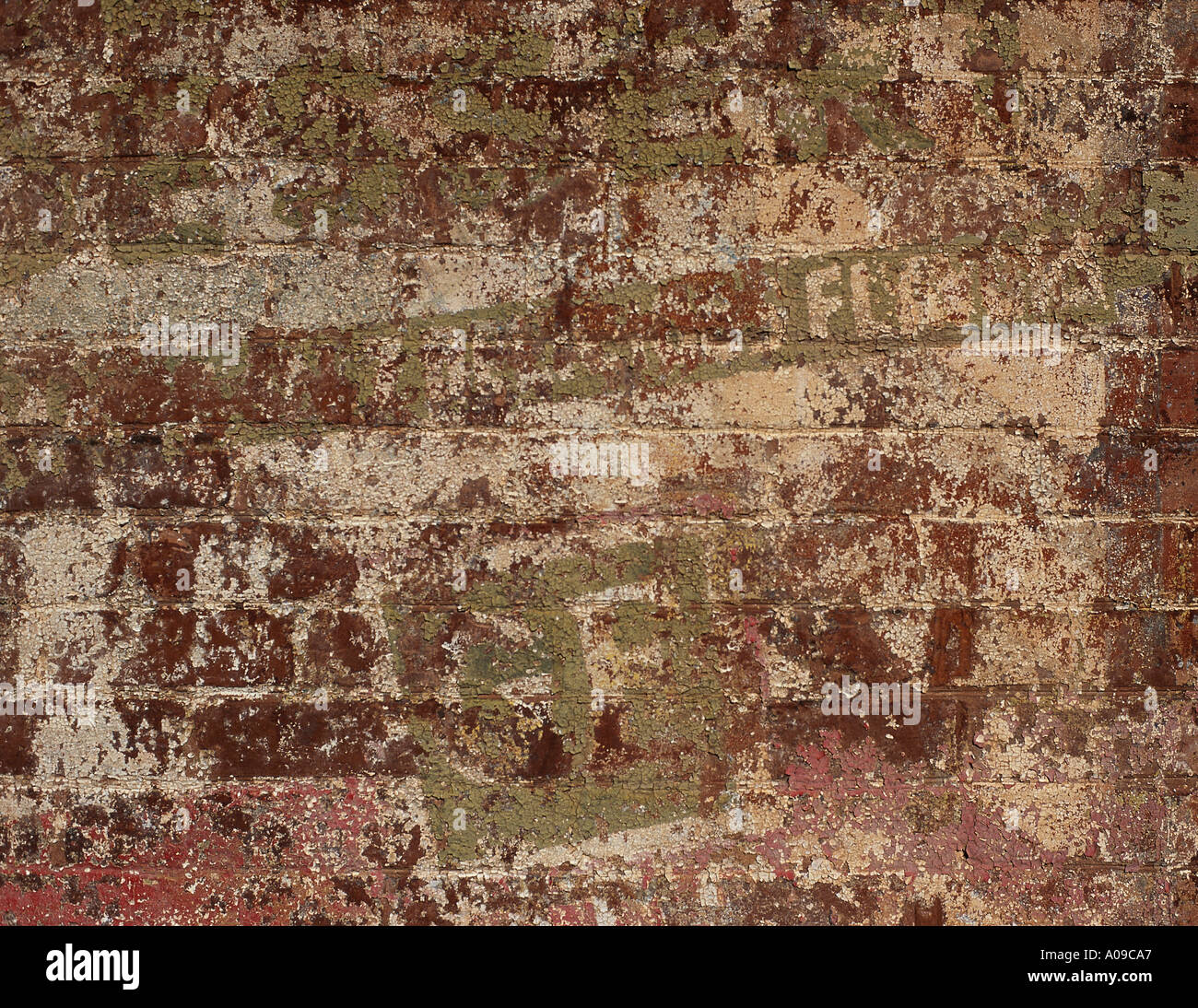 A close up of an aged and weathered brick wall with chipping flaking ...