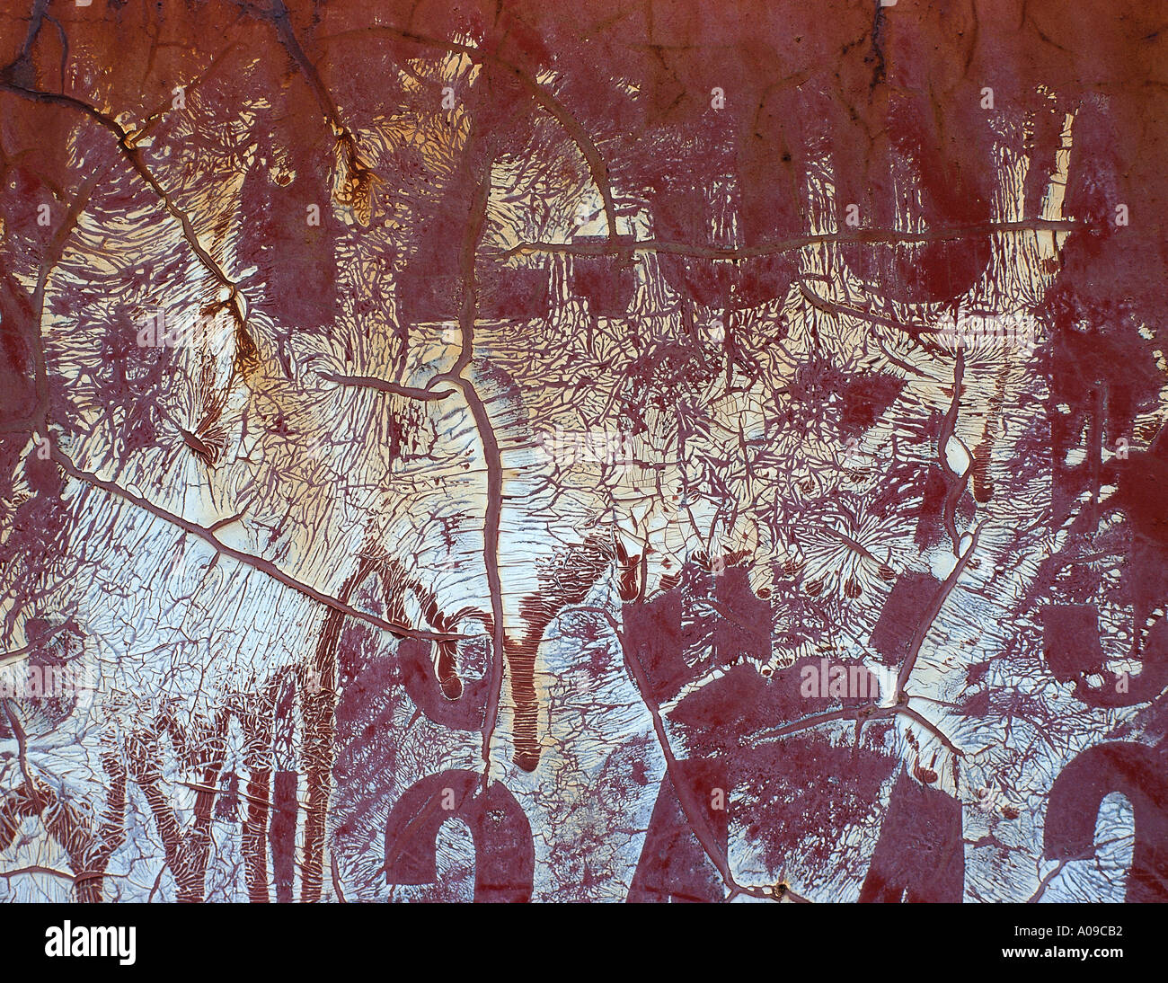 A close up of an aged and weathered metal surface with chipping flaking ...