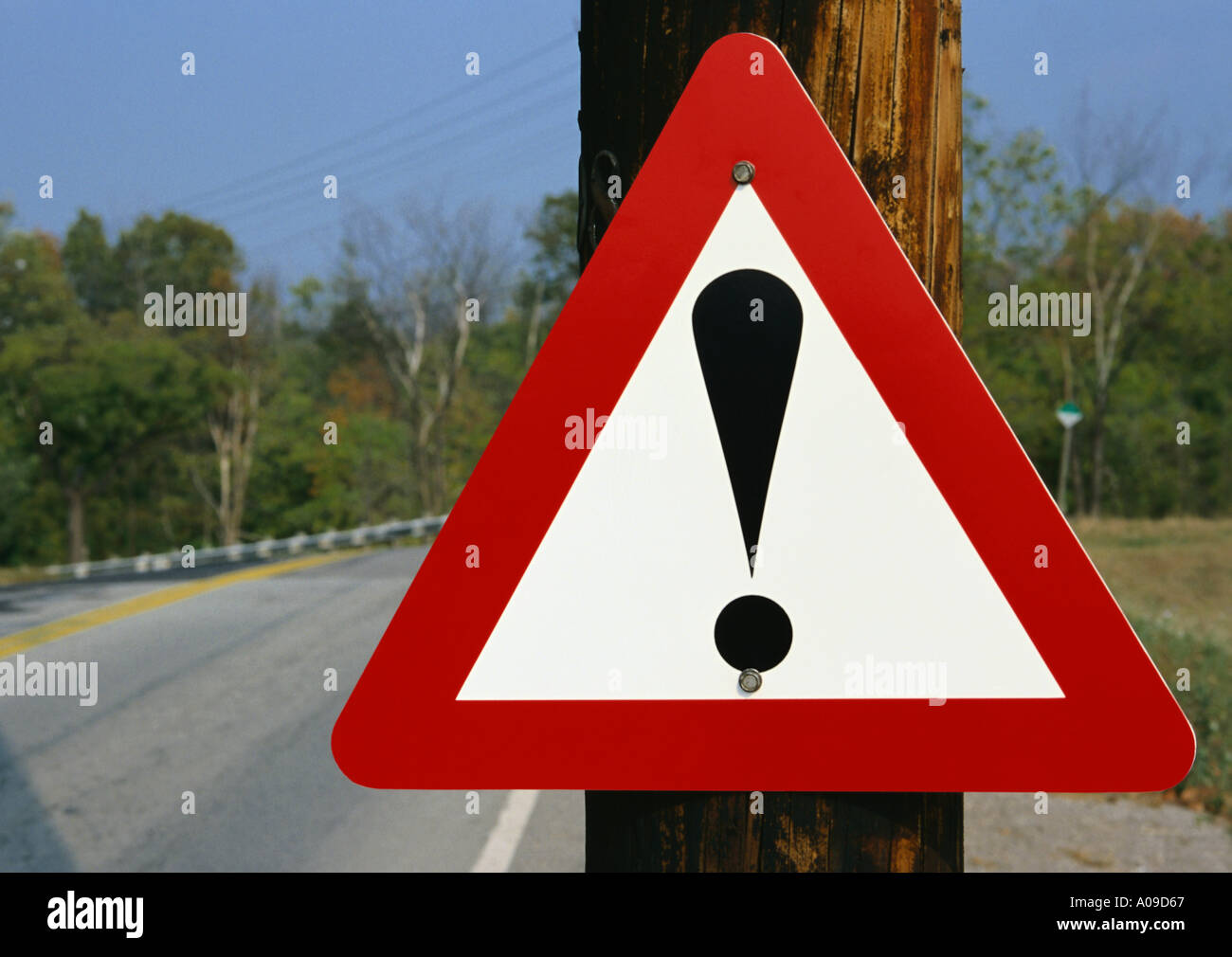 Triangular caution or danger road sign with an exclamation mark graphic ...