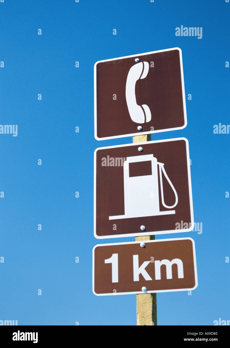 A brown and white road sign indicating a telephone and service station ...