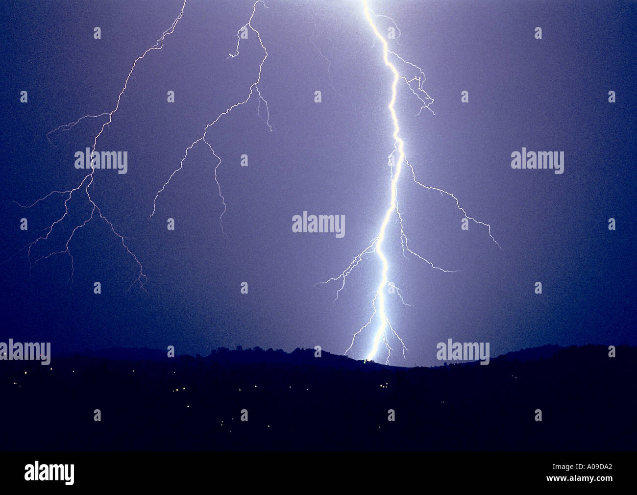 A flash of bright bolt lightening over a dark horizon and set against ...