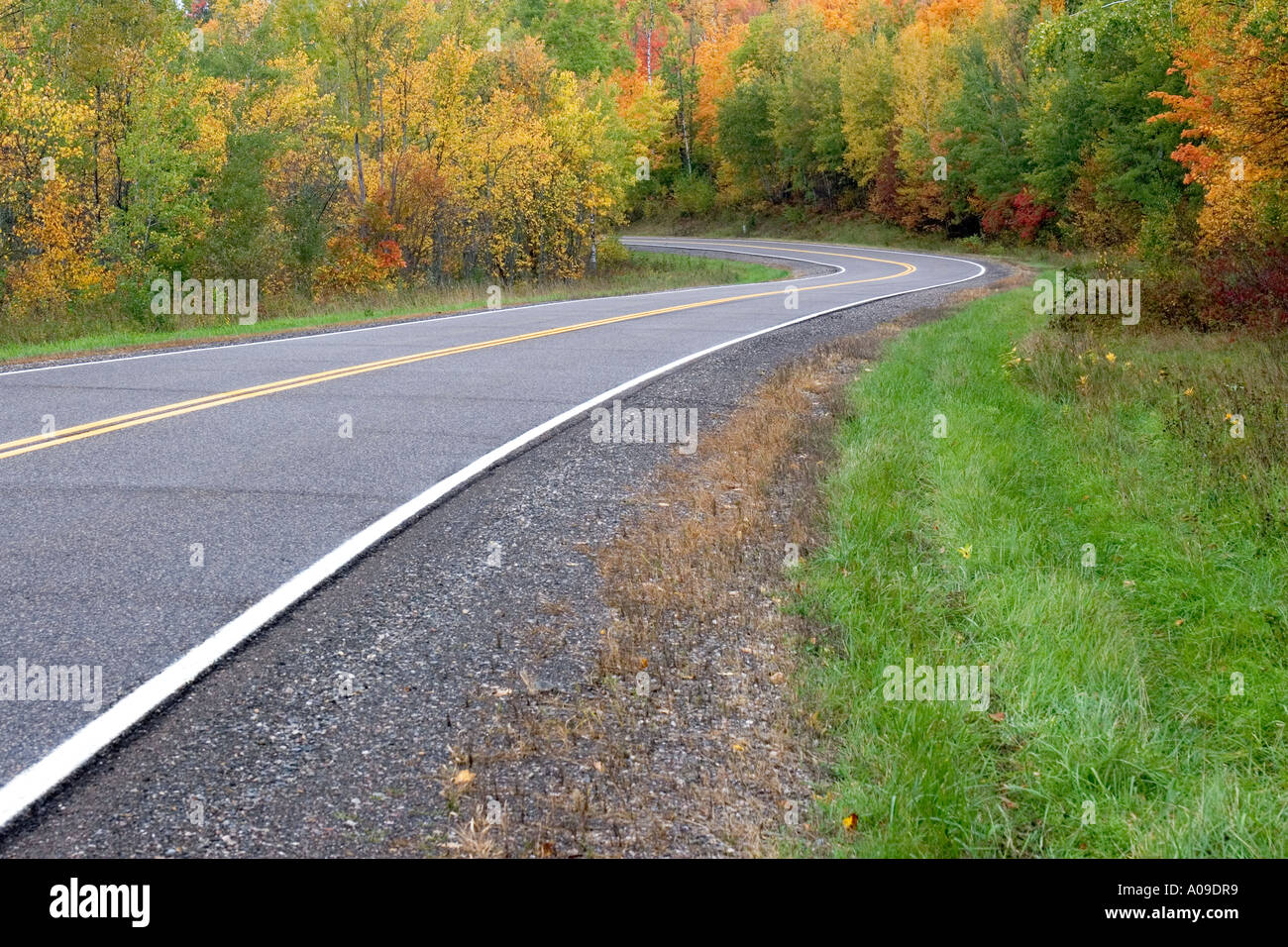 Road curving through autumn colors Stock Photo - Alamy