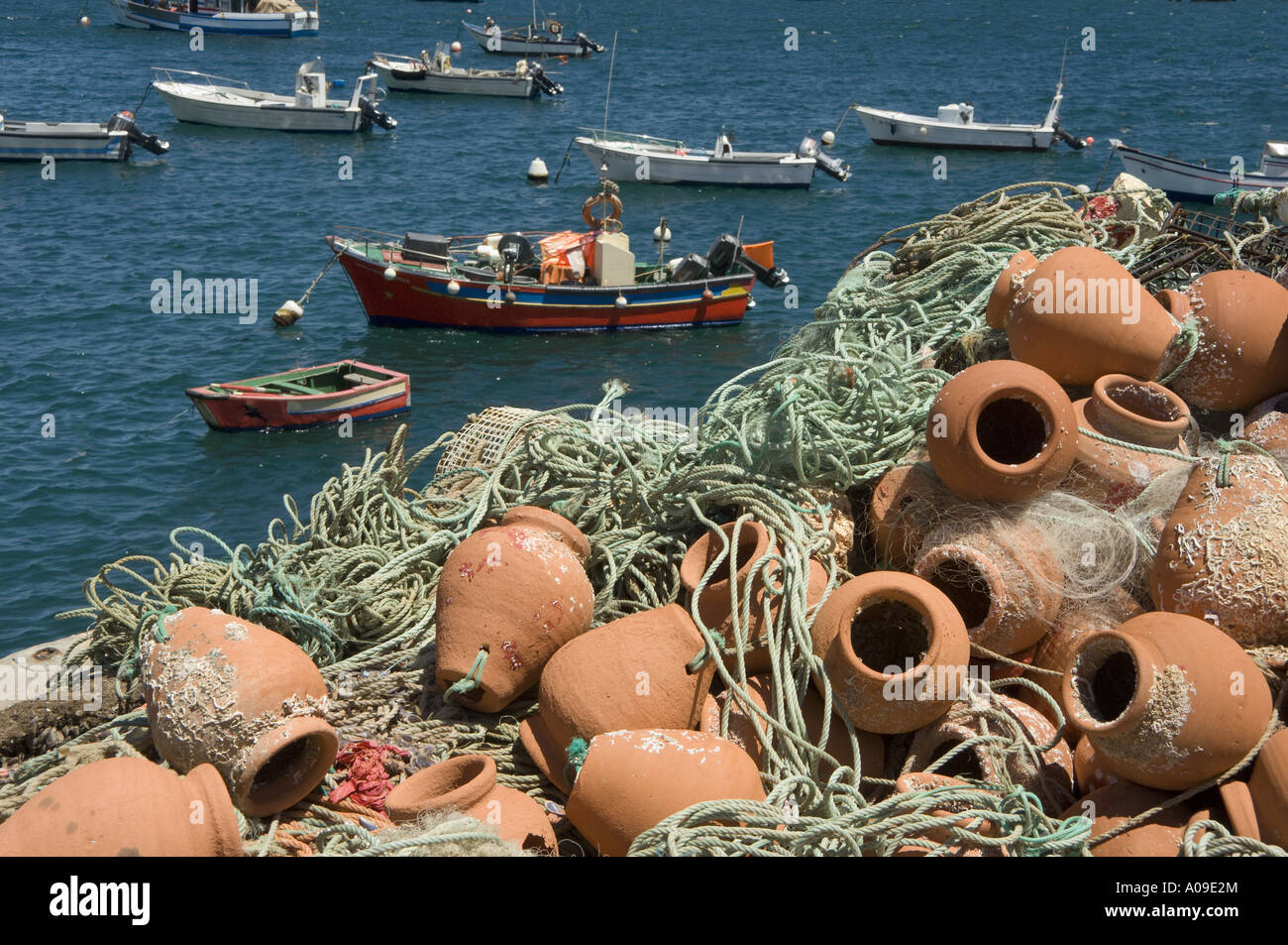crab pots and fishing boats in the Porto da baleeira harbour, Sagres ...