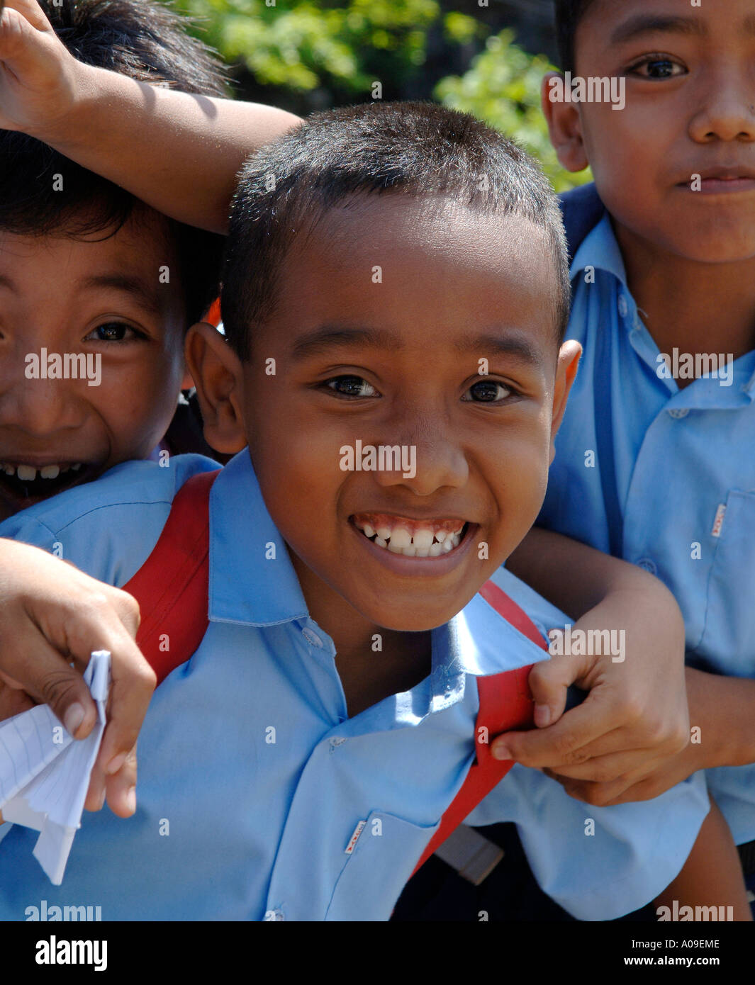 Balinese school children pose for the camera, Candidasa, Bali ...