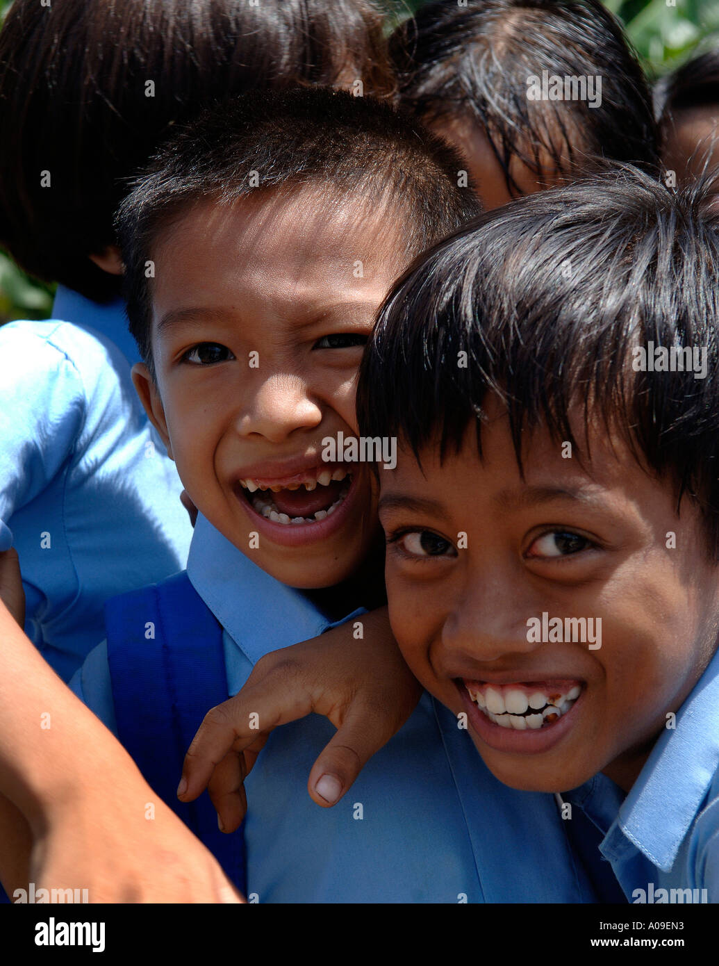 Balinese school children pose for the camera, Candidasa, Bali ...