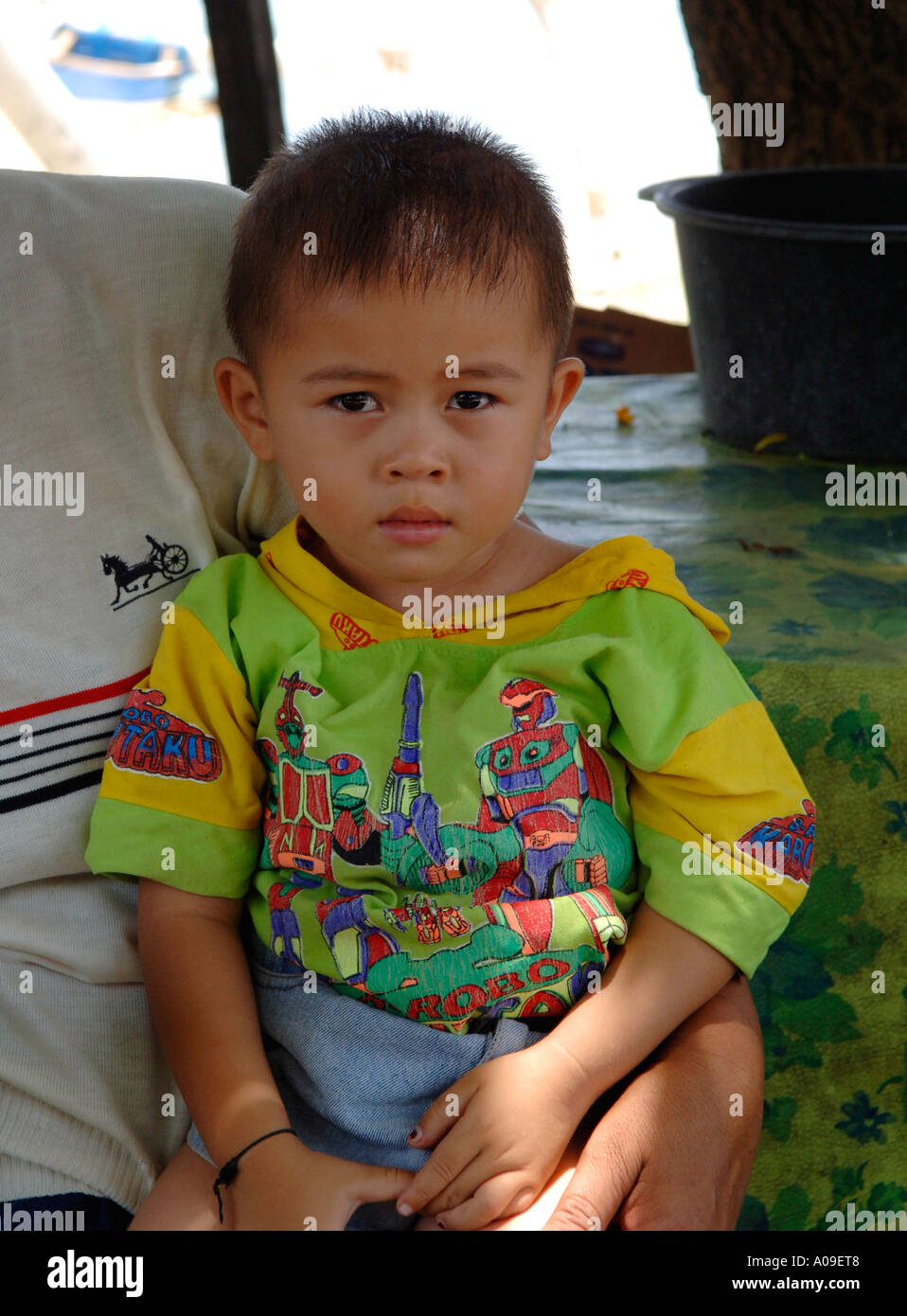 Little Indonesian boy looking pensive Stock Photo - Alamy