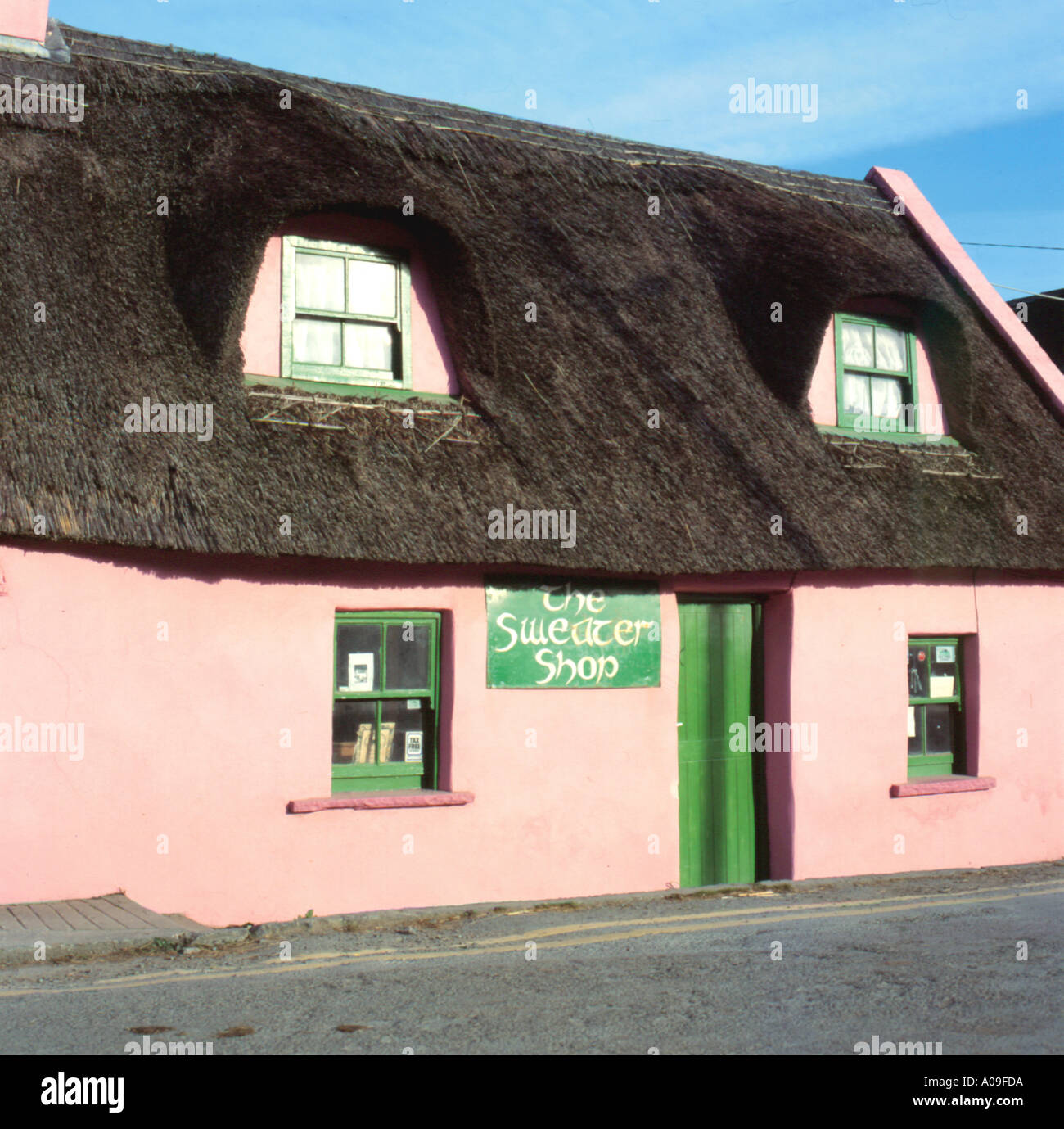 traditional thatched cottage with green door in Connemara, county ...