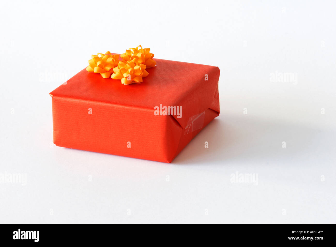 Gift in red color and orange wrapping Stock Photo - Alamy