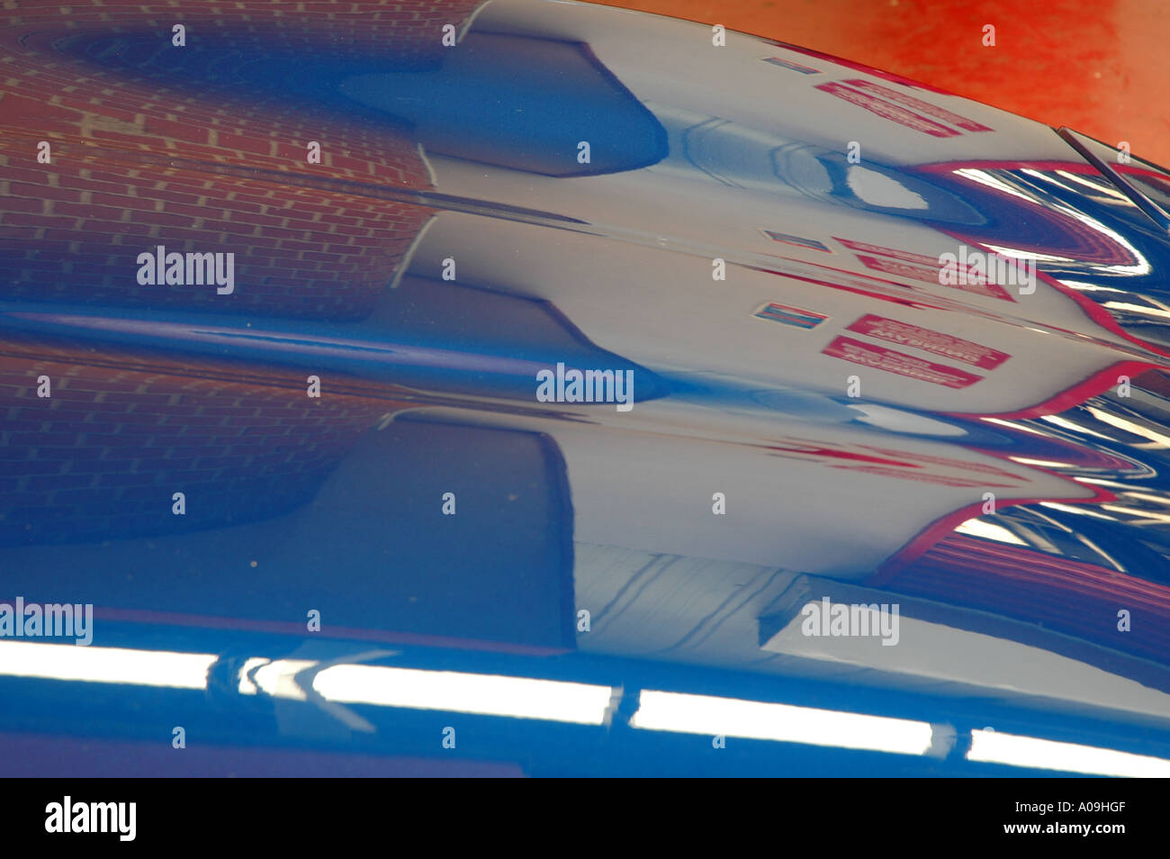 blue car bonnet reflecting brick Stock Photo - Alamy