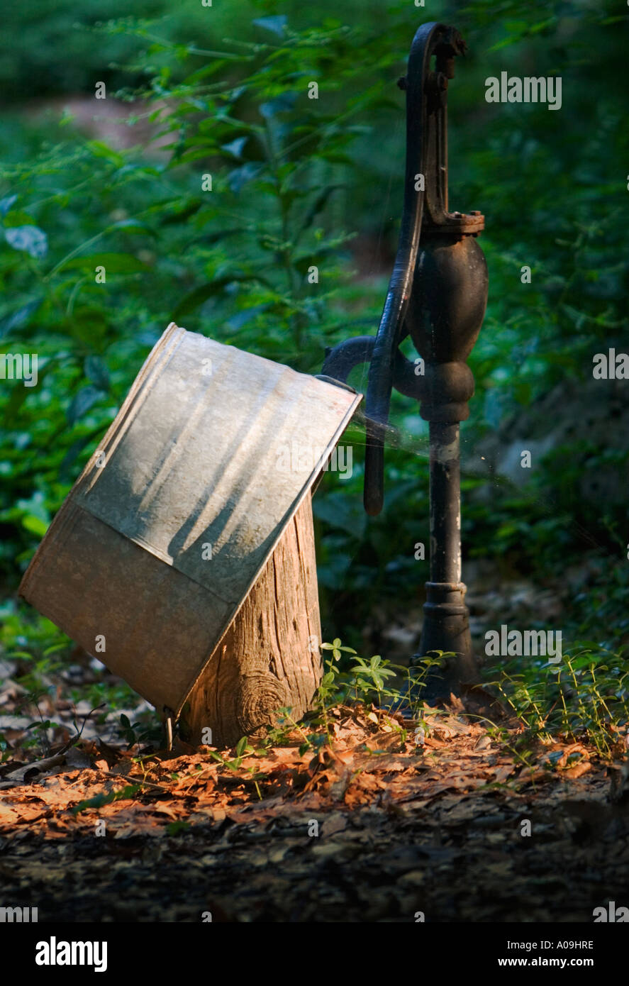 old galvinize wash bucket near hand water pump Stock Photo - Alamy