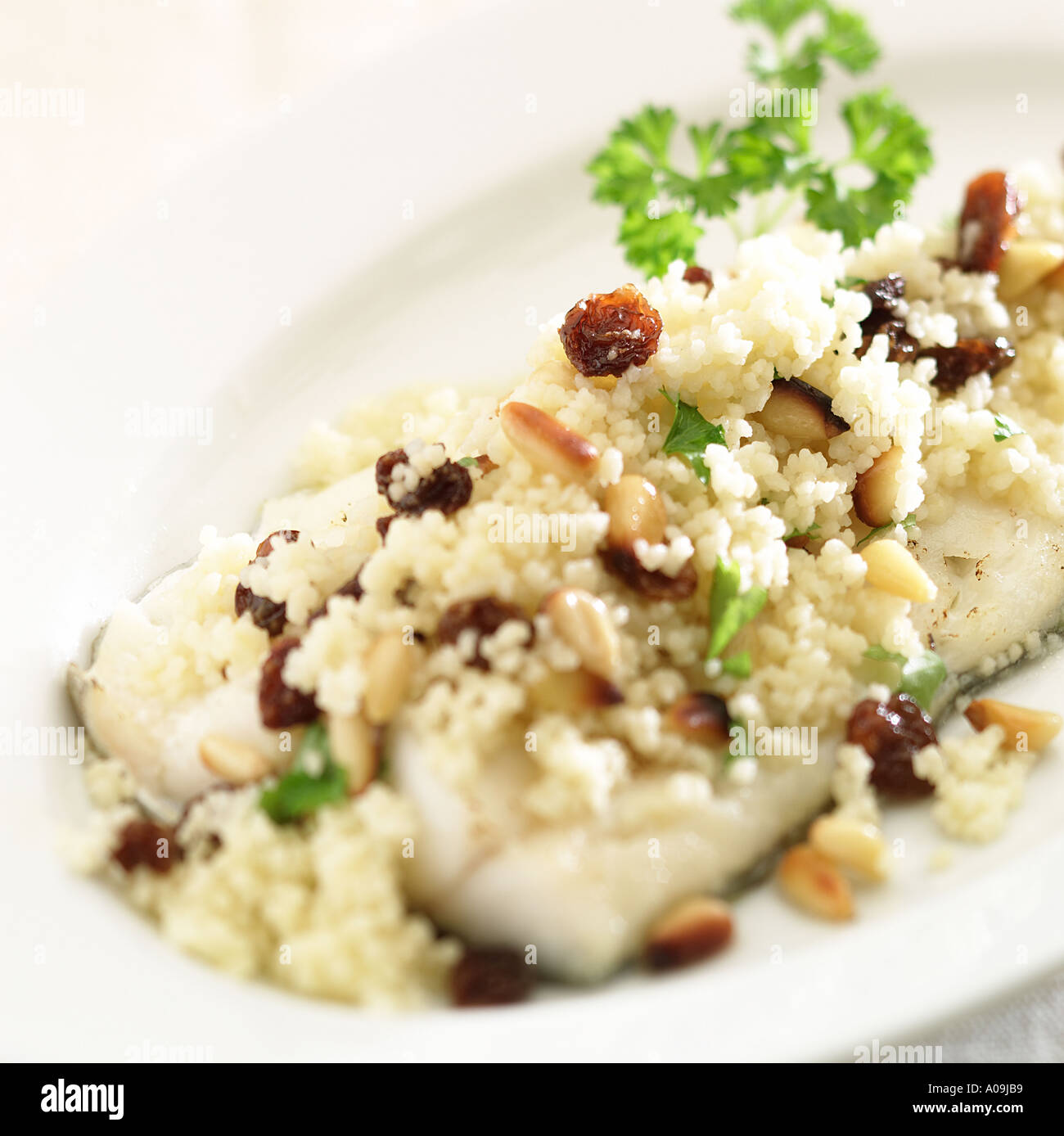 Baked cod with couscous sultanas pine kernels close up Keywords fish ...