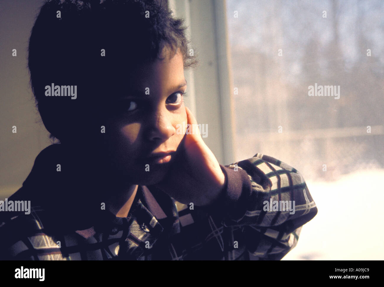 Sad young boy at the window St Paul Minnesota Stock Photo - Alamy
