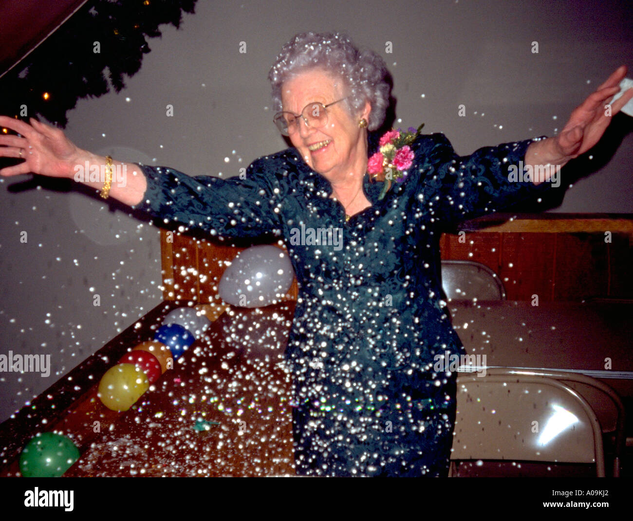 Grandmother age 82 celebrating with glitter at wedding reception. St ...