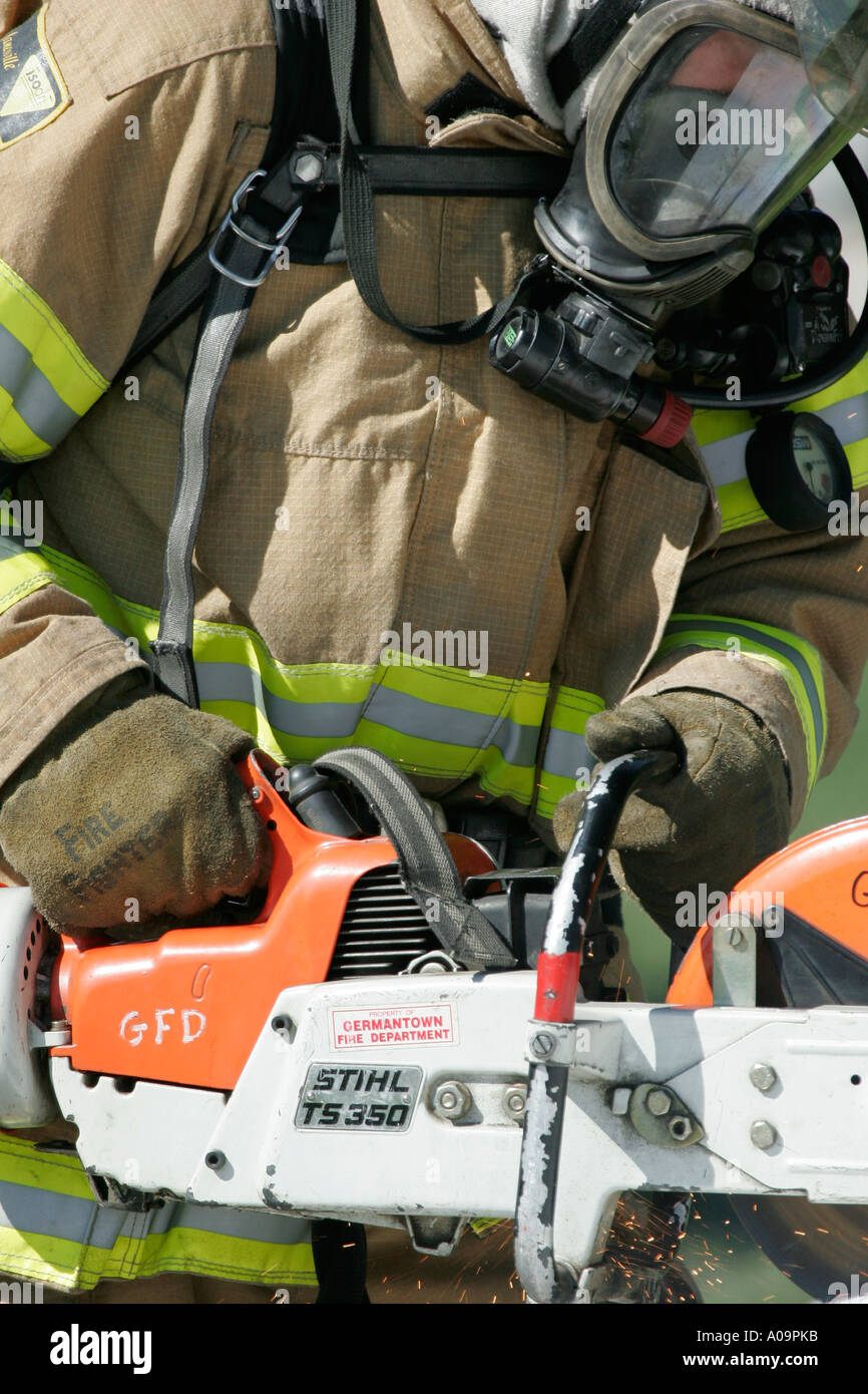 Fire fighter with a saw ready to cut into a vehicle Stock Photo - Alamy
