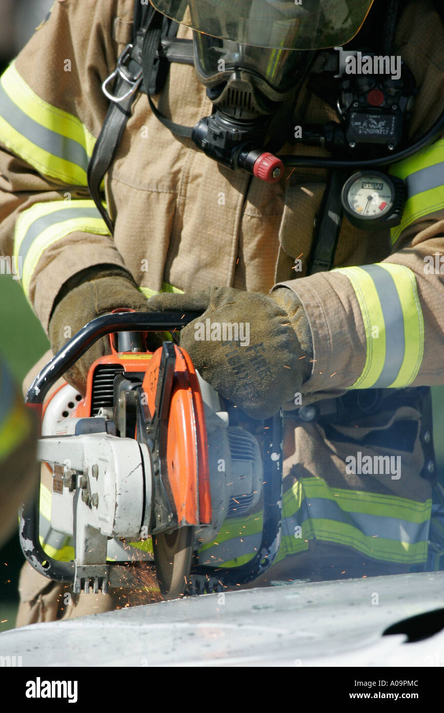 Fire fighter cutting into a car Stock Photo - Alamy