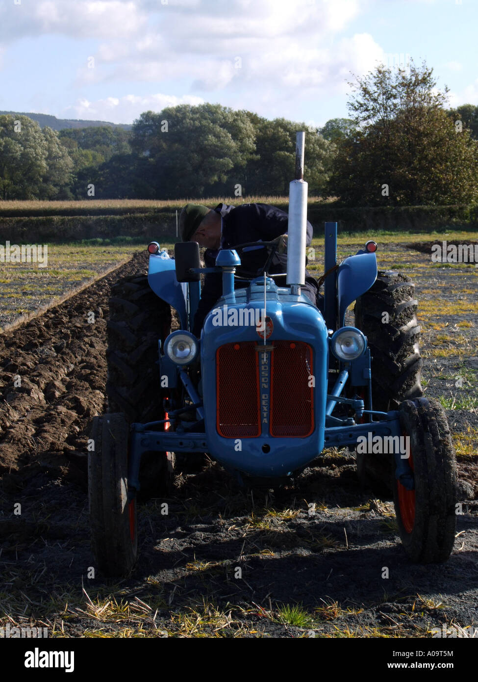 Tractor ploughing with furrow plough Stock Photo - Alamy