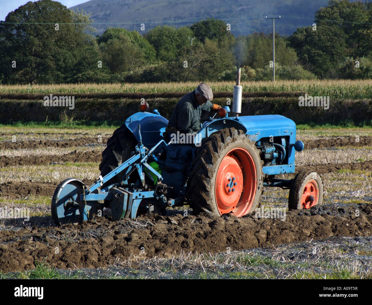 Tractor ploughing with furrow plough Stock Photo - Alamy