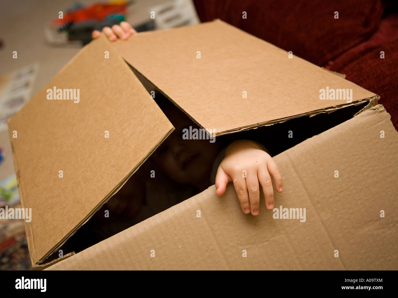 Boy stuck in box Stock Photo - Alamy
