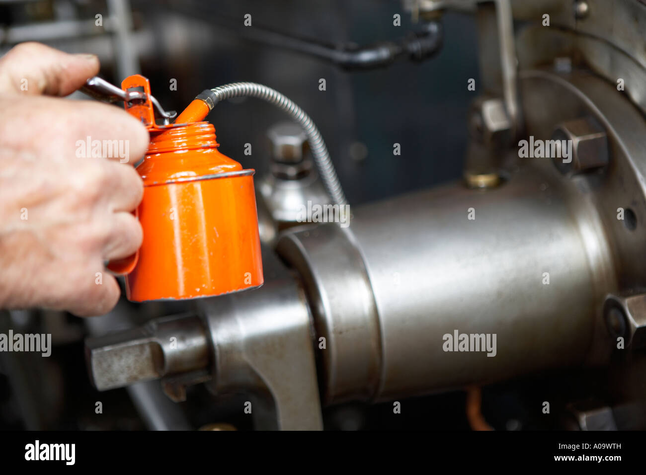 Engineer oiling a steam engine in a heritage museum Stock Photo - Alamy