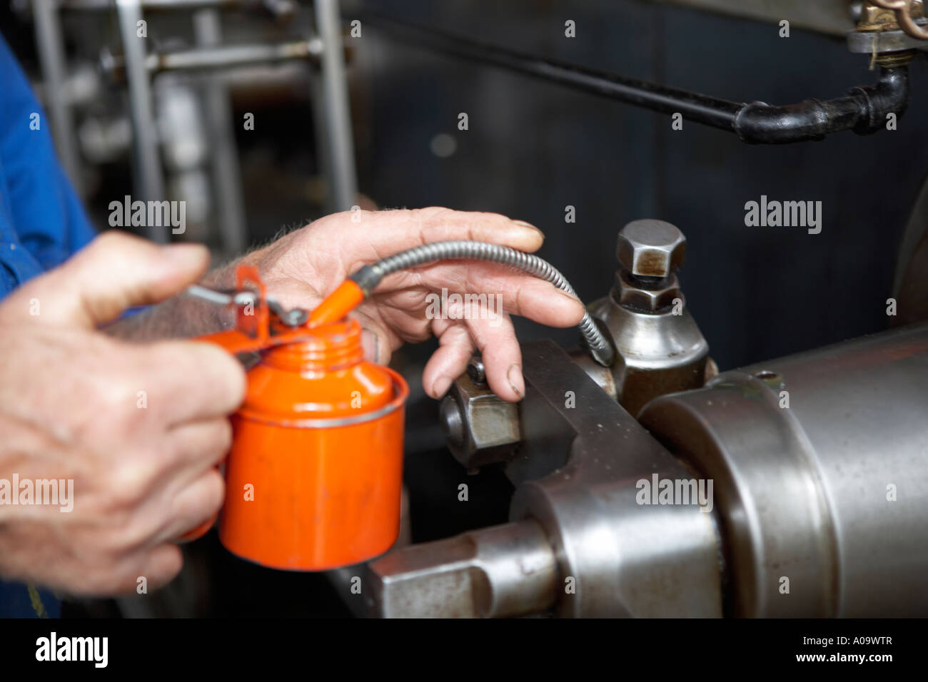 Engineer oiling a steam engine in a heritage museum Stock Photo - Alamy