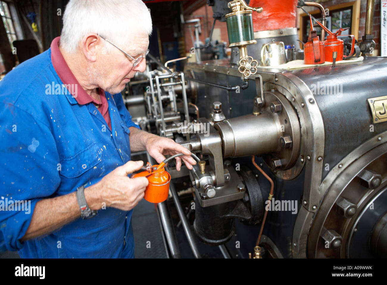 Engineer oiling a steam engine in a heritage museum Stock Photo - Alamy