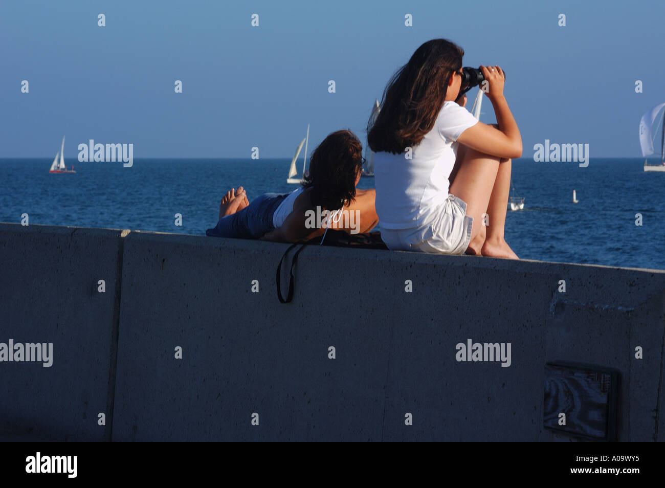 Girls Watching Sailboats Stock Photo - Alamy