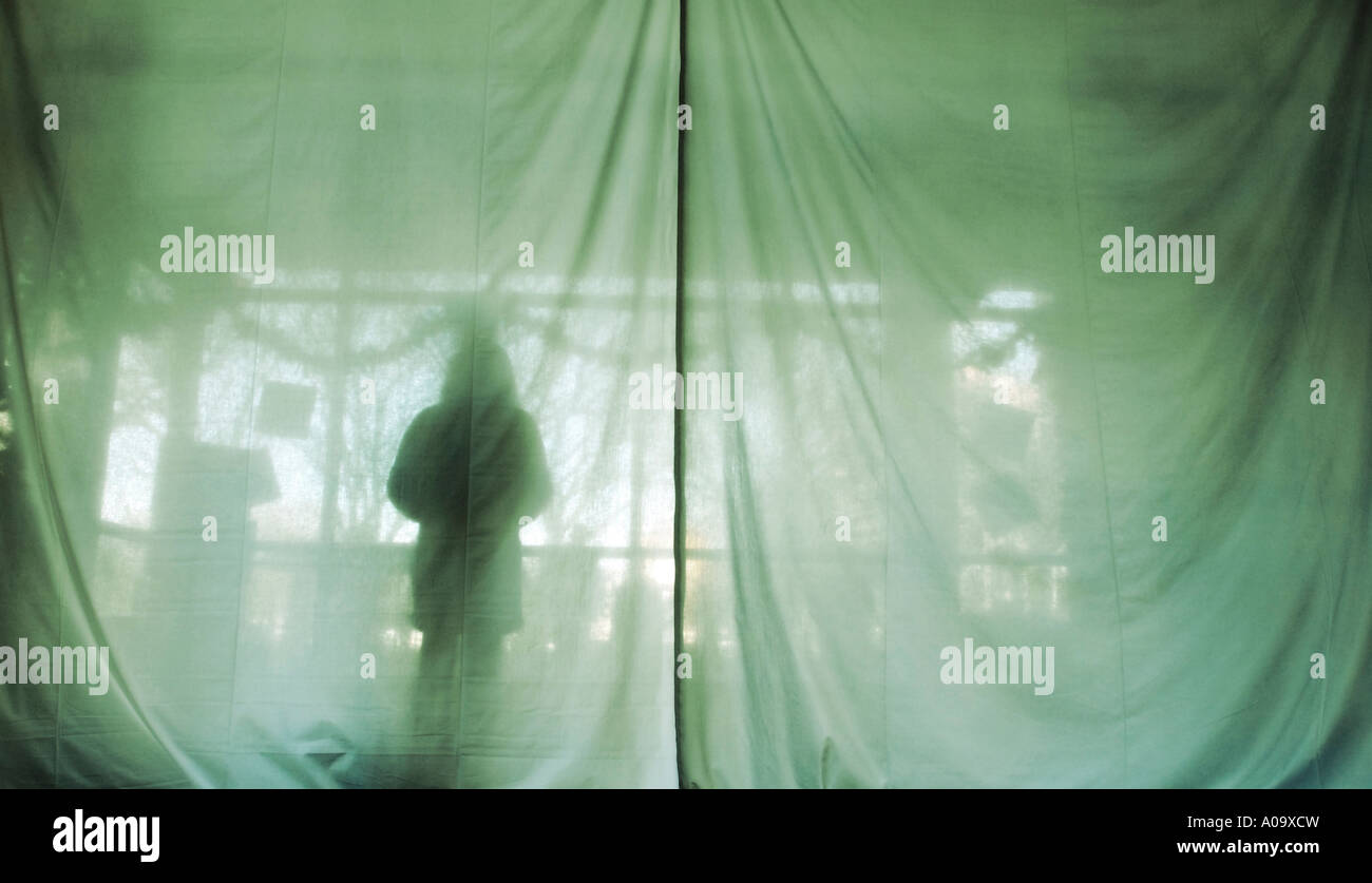 Shadow behind drapes and large picture window silhouette Stock Photo ...