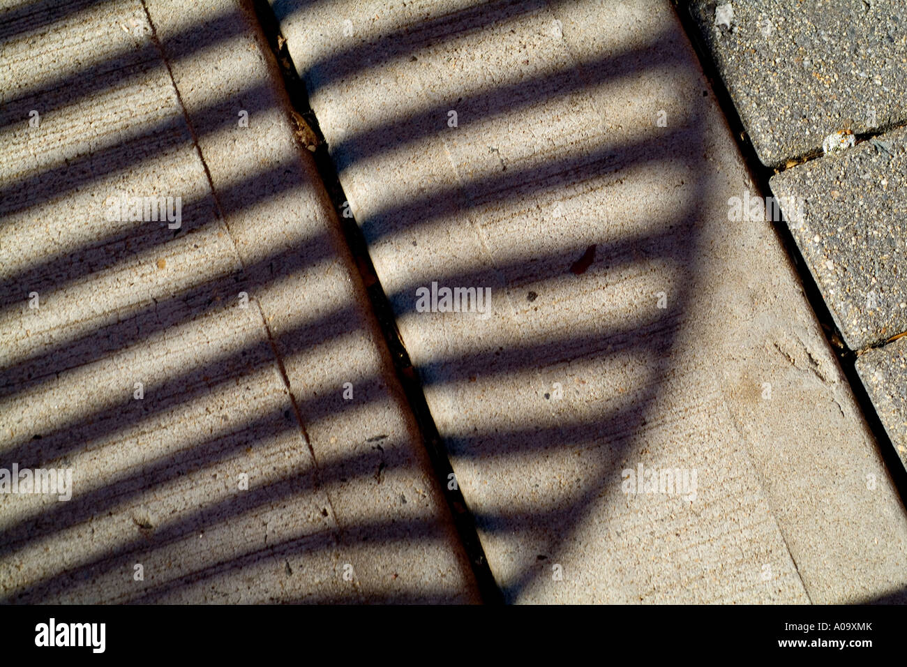 Shadow cast on sidewalk forms an urban abstract Stock Photo - Alamy