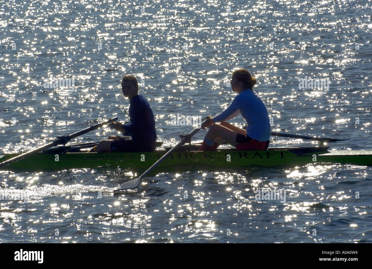 Pairs skulling practice reflection outline sunlight resting rowing oars ...