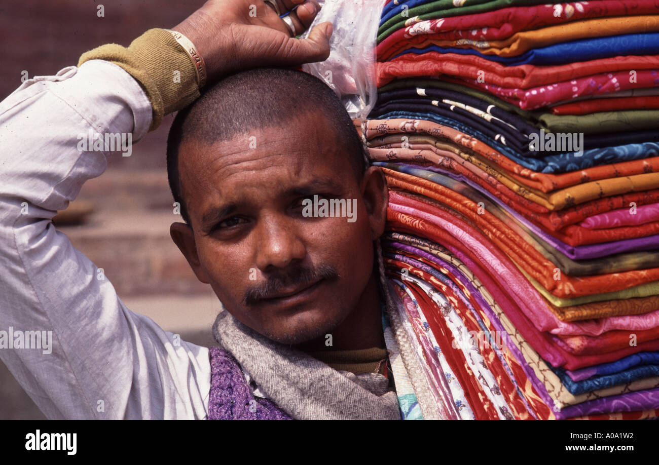 Man carrying fabrics Stock Photo - Alamy